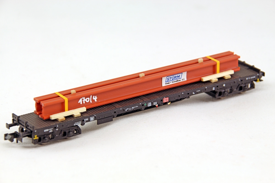 2 large steel beams on wooden support beams - E-trains