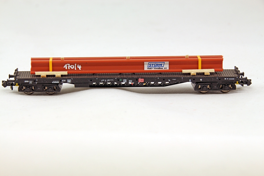 2 large steel beams on wooden support beams - E-trains